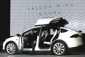 Tesla delivers Model X electric SUV to take on luxury carmakers ...